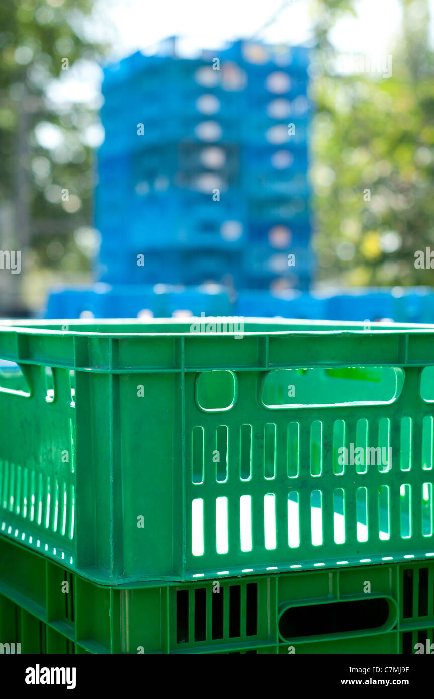 Green plastic crates. Blurred blue background Stock Photo - Alamy