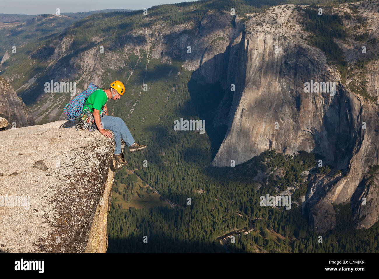 Male rock climber celebrates on the summit after a successful ascent ...