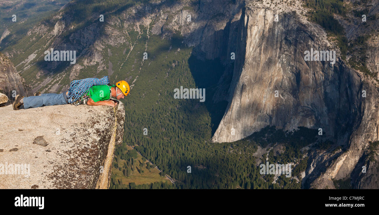 Male rock climber celebrates on the summit after a successful ascent ...