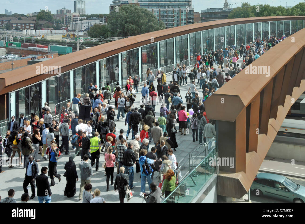 Crowds of people shoppers on footbridge link above railway from ...