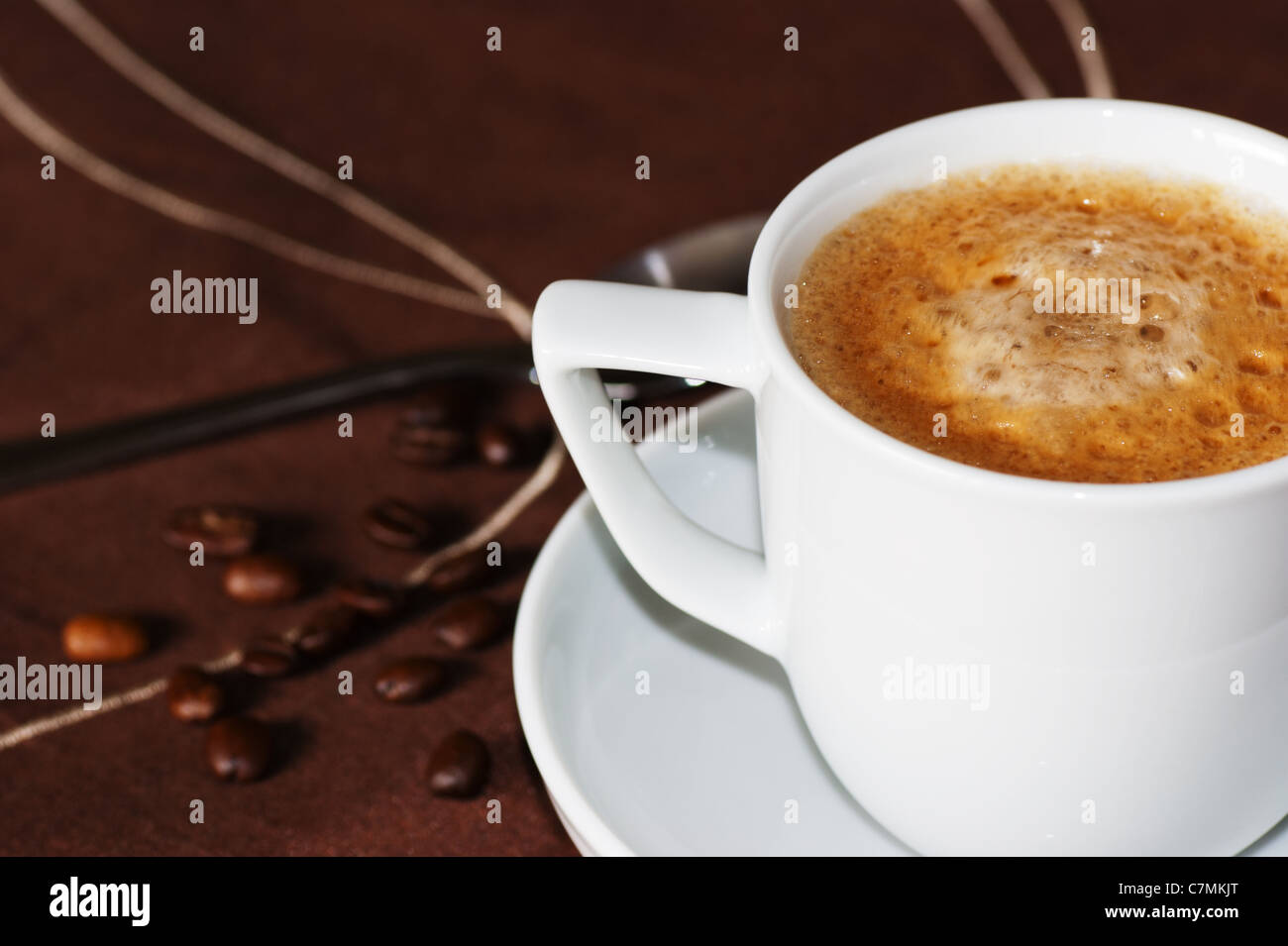 A cup of frothy black coffee Stock Photo - Alamy