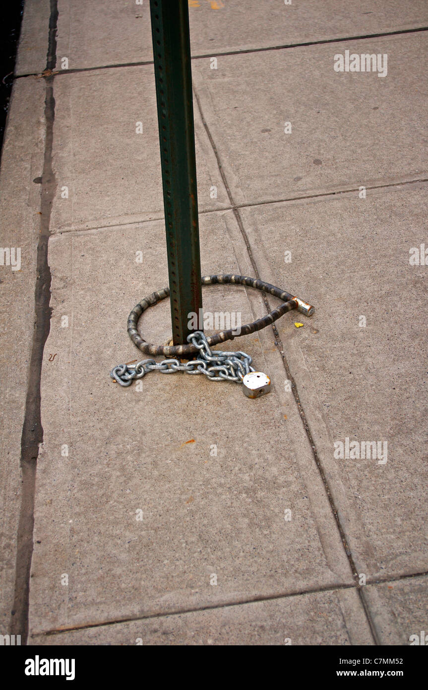 Bicycle lock and chain attached to a metal post but no bicycle Stock ...