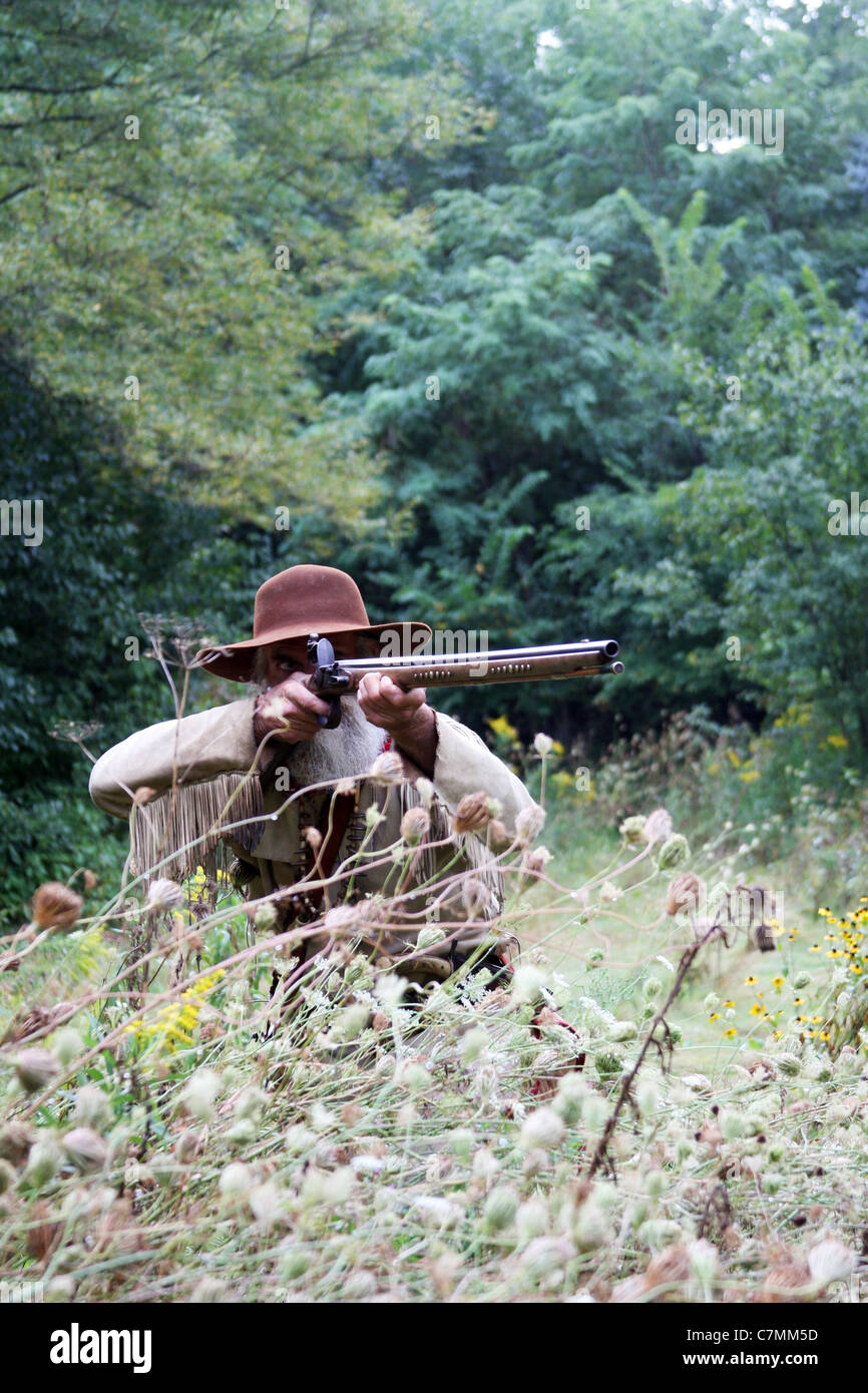 An early american hunter hunting in the woods Stock Photo - Alamy