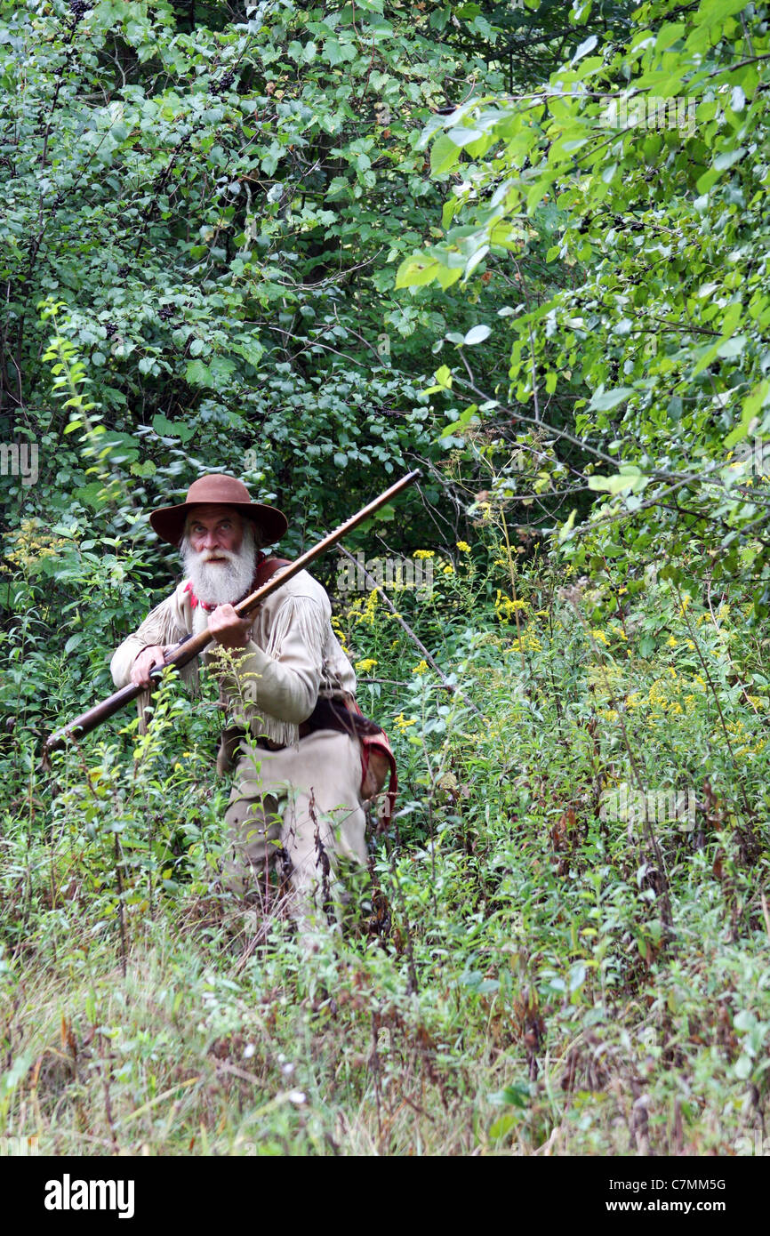 An early american hunter hunting in the woods Stock Photo - Alamy