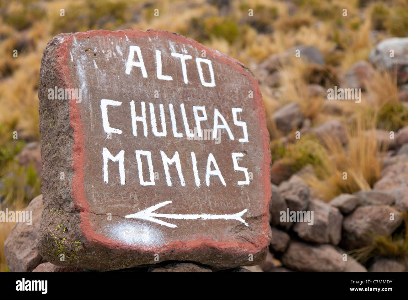 Painted sign on a rock leading to the chullpas and momias (mummies ...