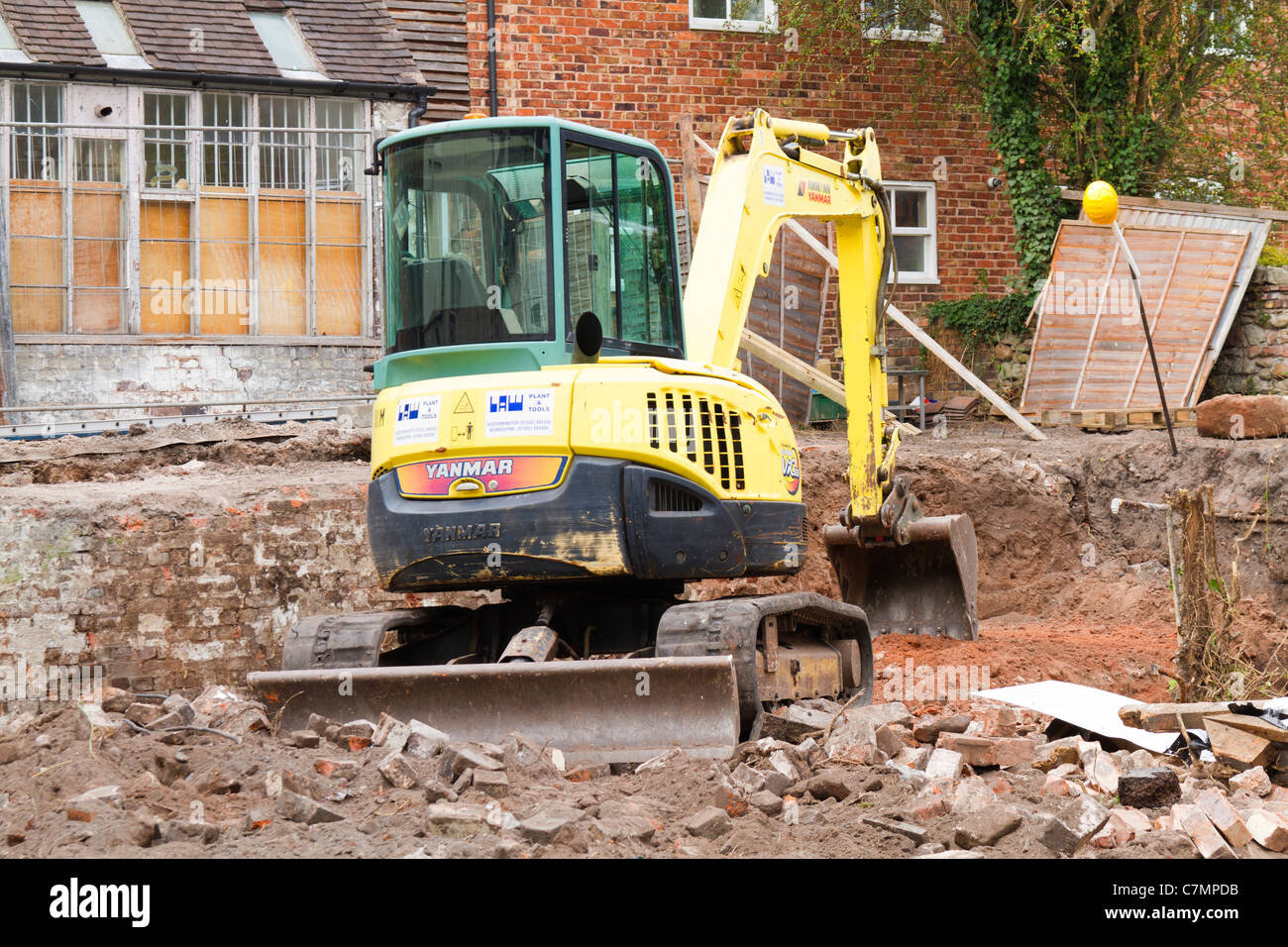 Mini excavator on a small building site Stock Photo - Alamy