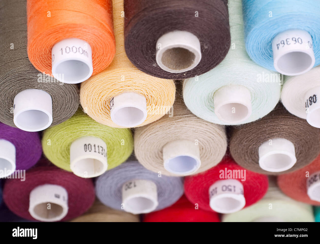 Sewing thread on bobbin closeup view background Stock Photo - Alamy