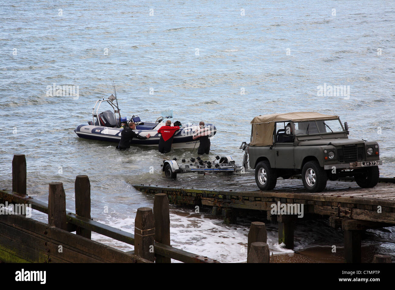 Launching boat into sea Stock Photo - Alamy