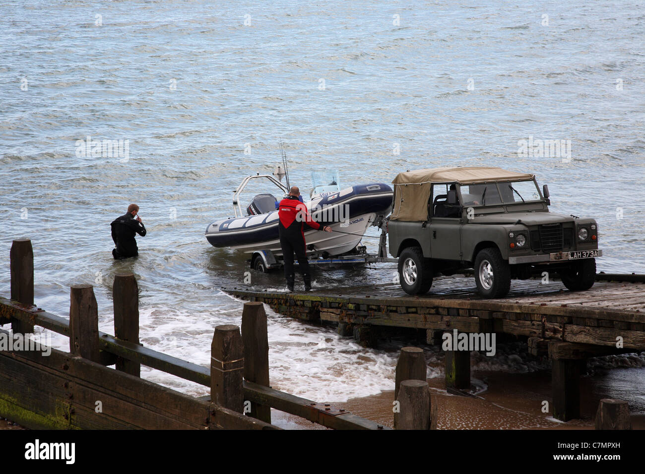 Launching boat into sea Stock Photo - Alamy