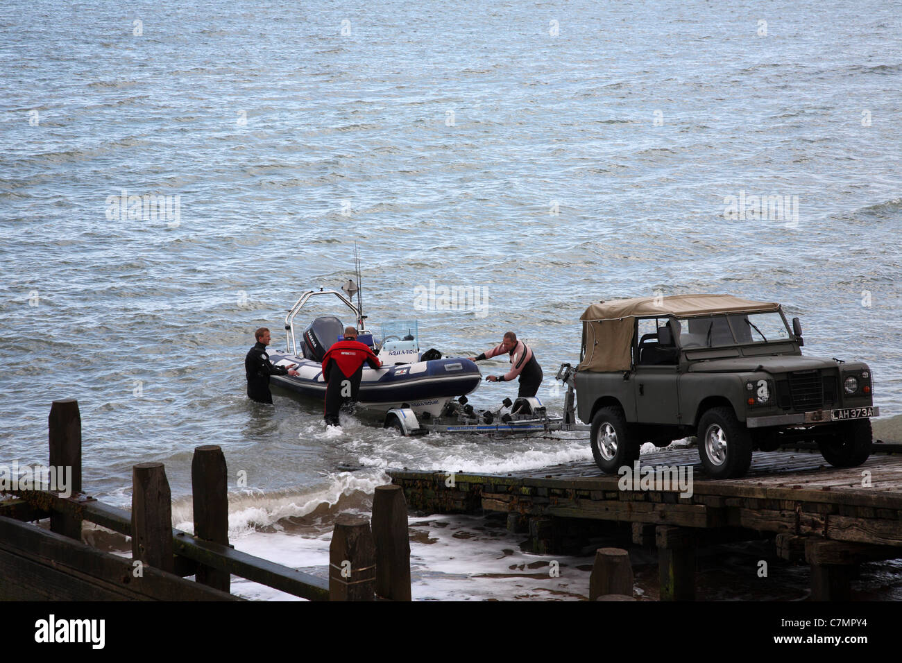 Launching boat into sea Stock Photo - Alamy