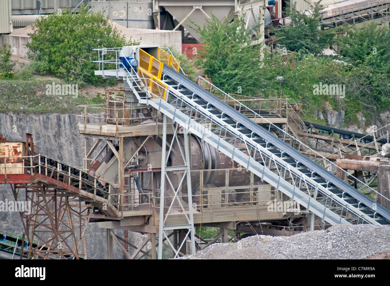 A conveyor belt is set up in a large quarry for transporting stone ...