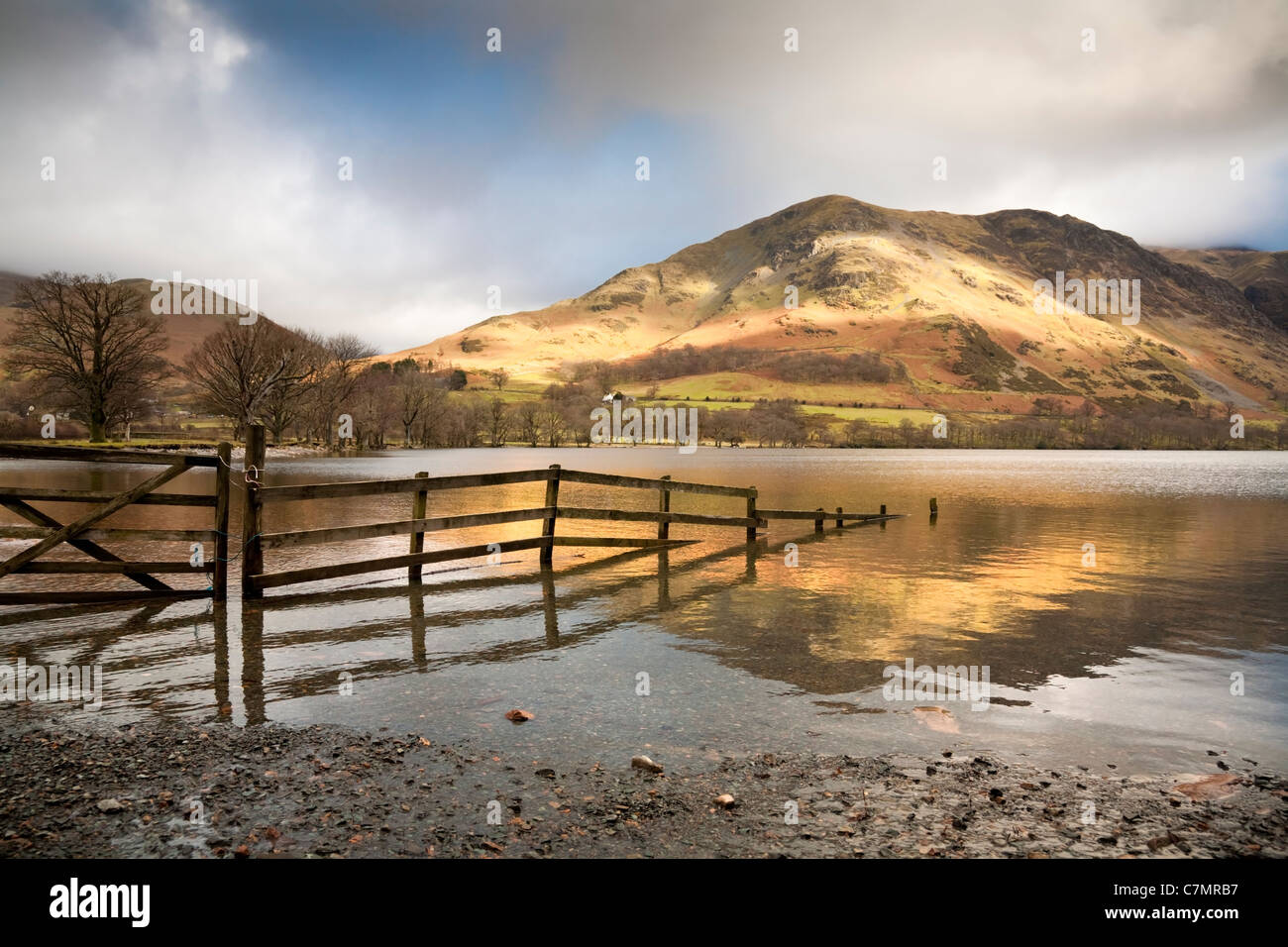 Fence disappearing into Lake Buttermere, Cumbria, Lake District ...