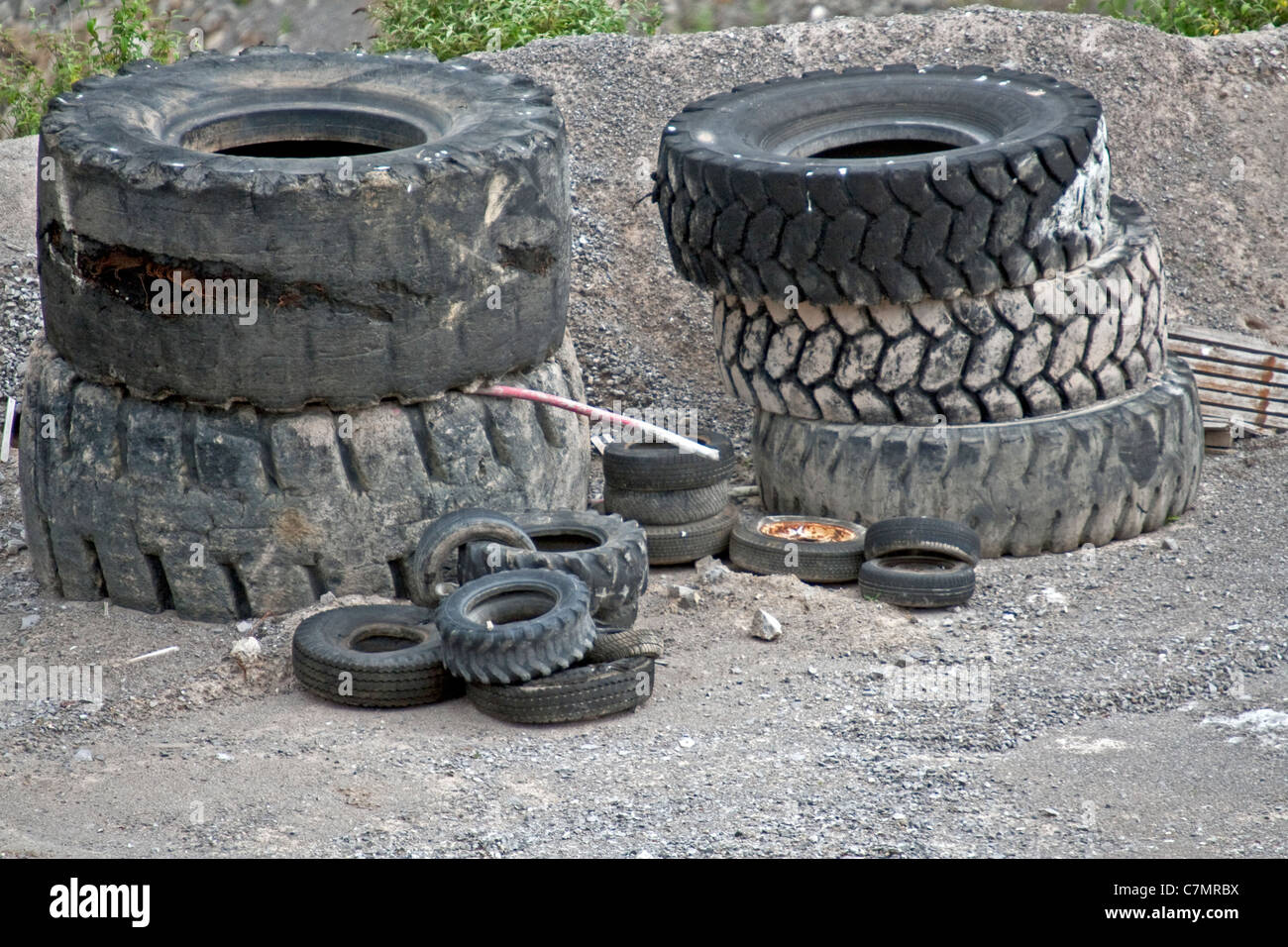 Worn-out tyres are discarded in a quarry, contributing to environmental ...