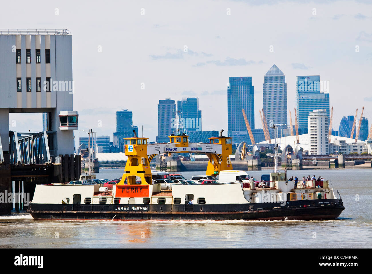 Woolwich ferry crossing the river Thames with Canary wharf behind Stock ...