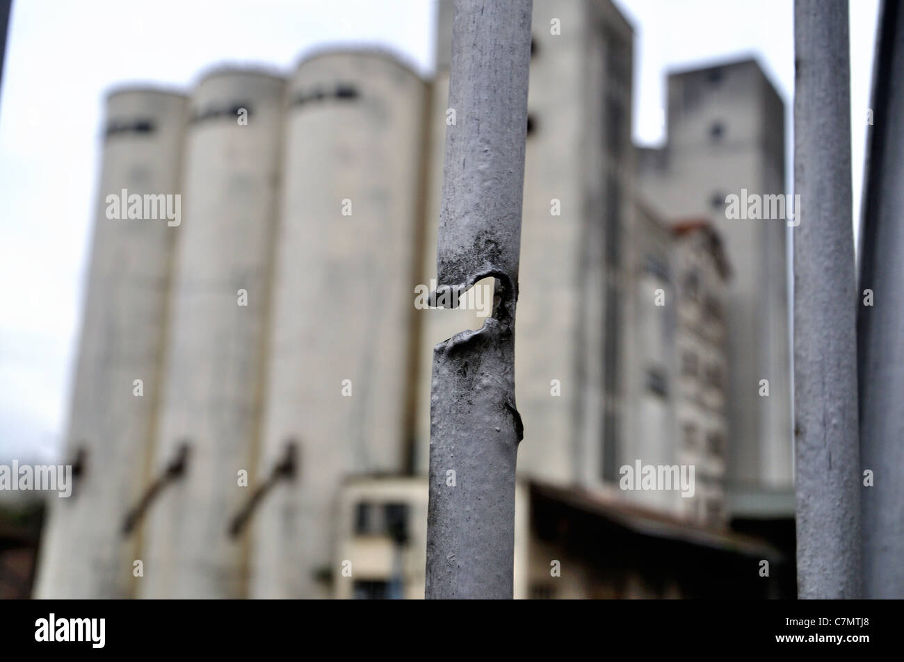 Foreground Damaged railing at an Industrial Storage containers and ...