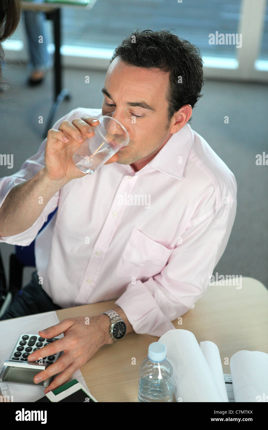 Man drinking water at work Stock Photo - Alamy