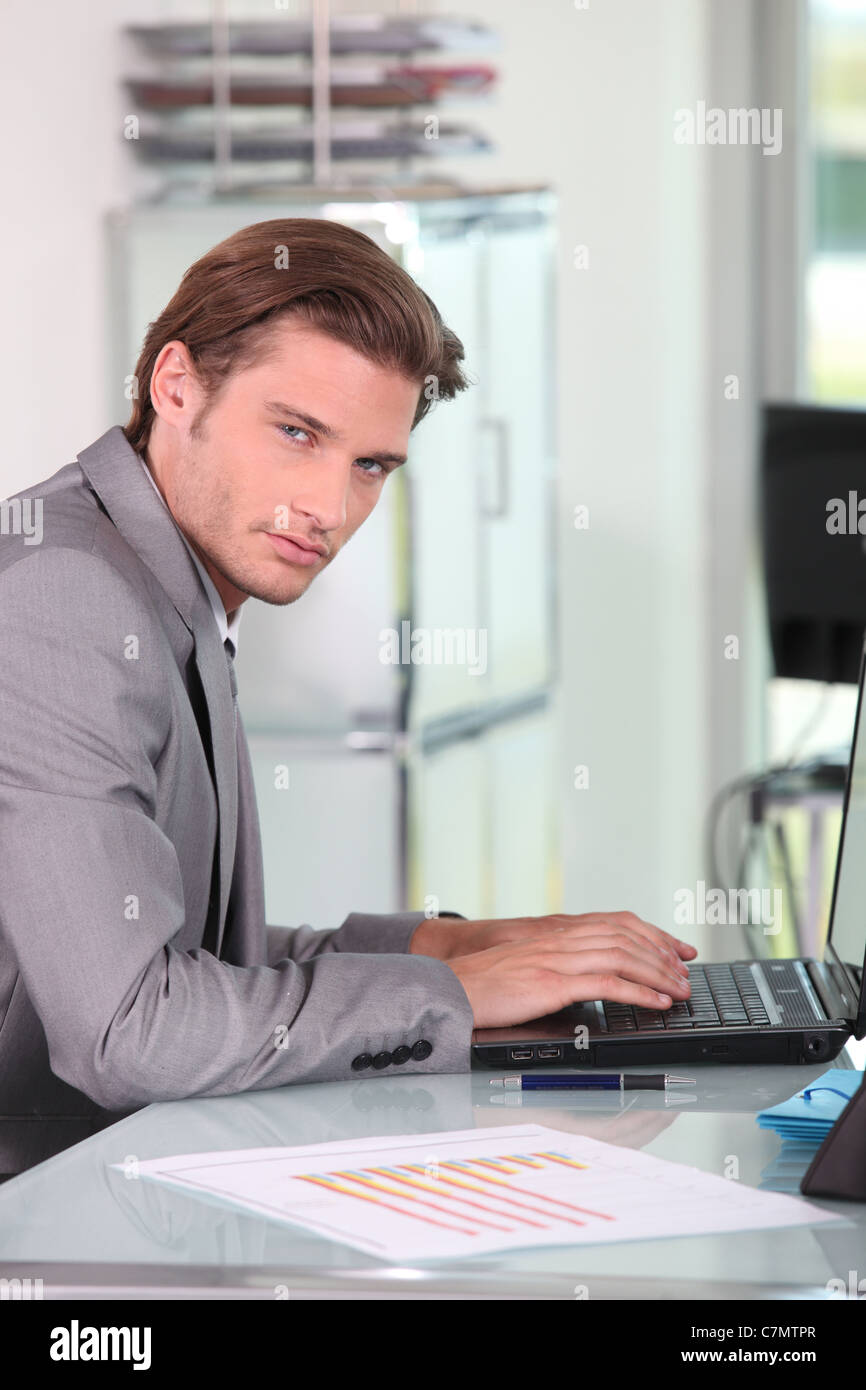 Young businessman on laptop Stock Photo - Alamy