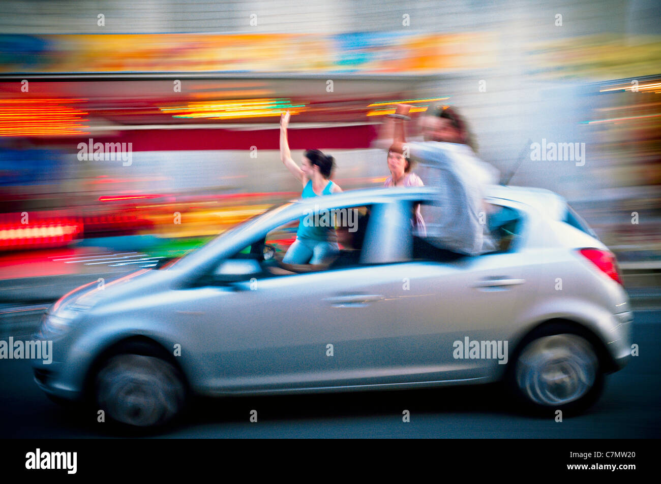 Speeding car with passengers sitting on window cills - France Stock ...