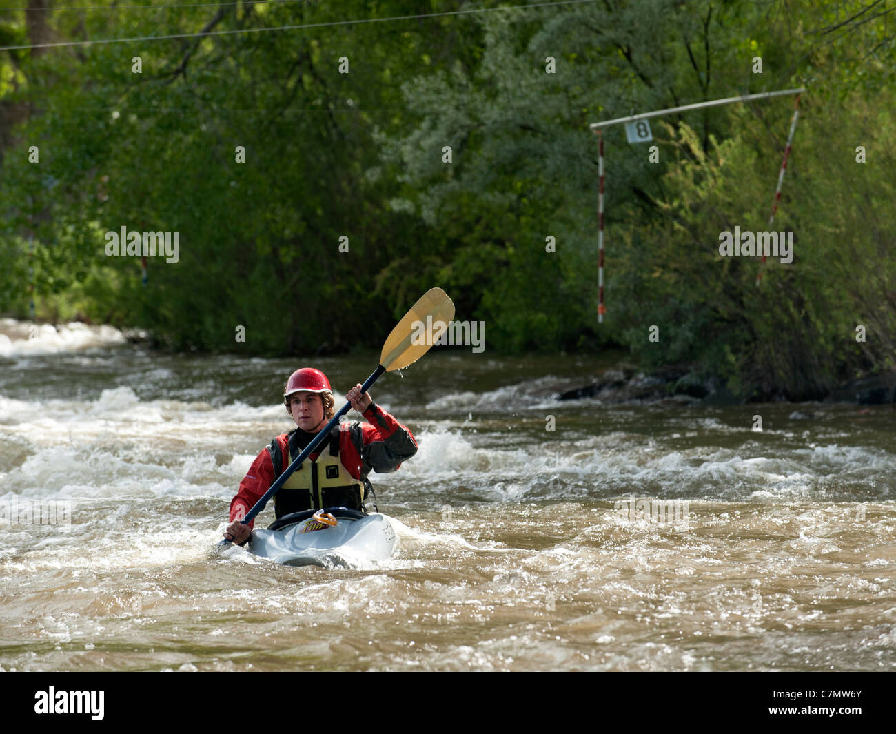 A whitewater kayaker runs the slalom course at Golden, Colorado's Clear ...