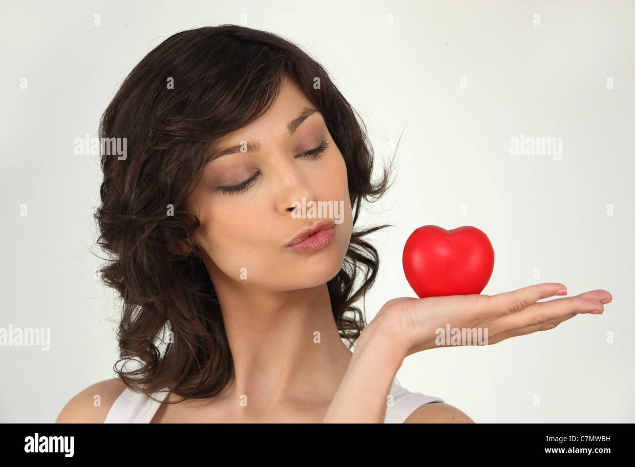 Woman with a heart laying on the palm of her hand Stock Photo - Alamy