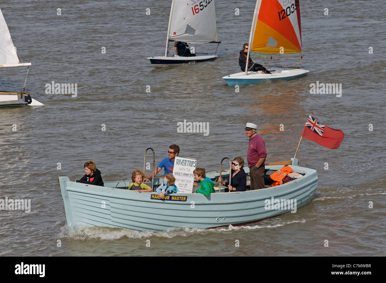 John White harbour master taking tourists for a trip on river Deben ...