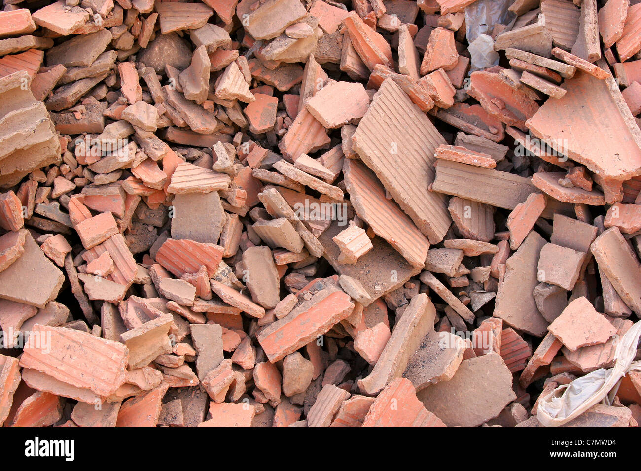 Rubble composed of red broken bricks in an old demolished building ...
