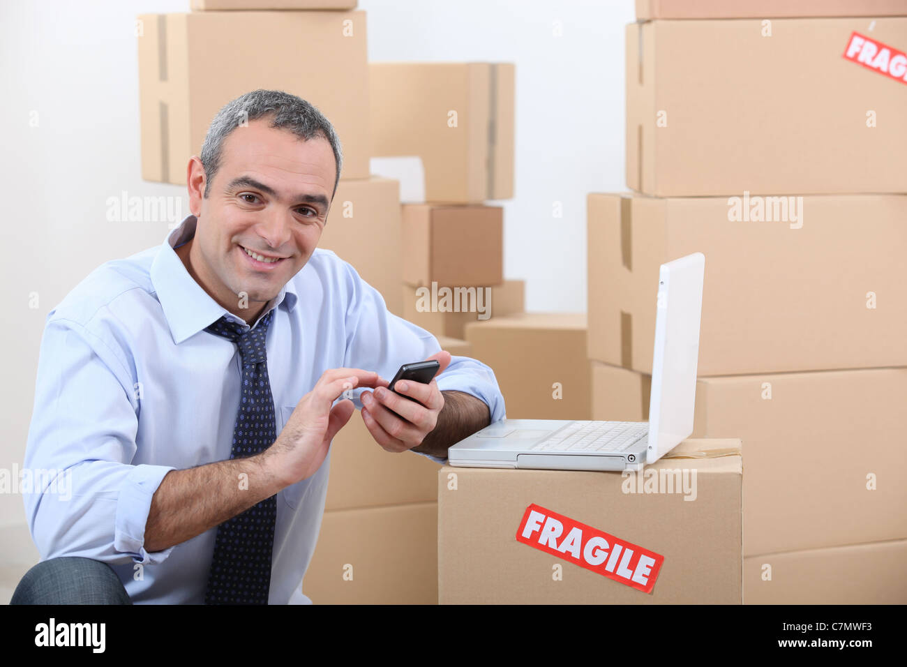 portrait of a man with cardboard boxes Stock Photo - Alamy