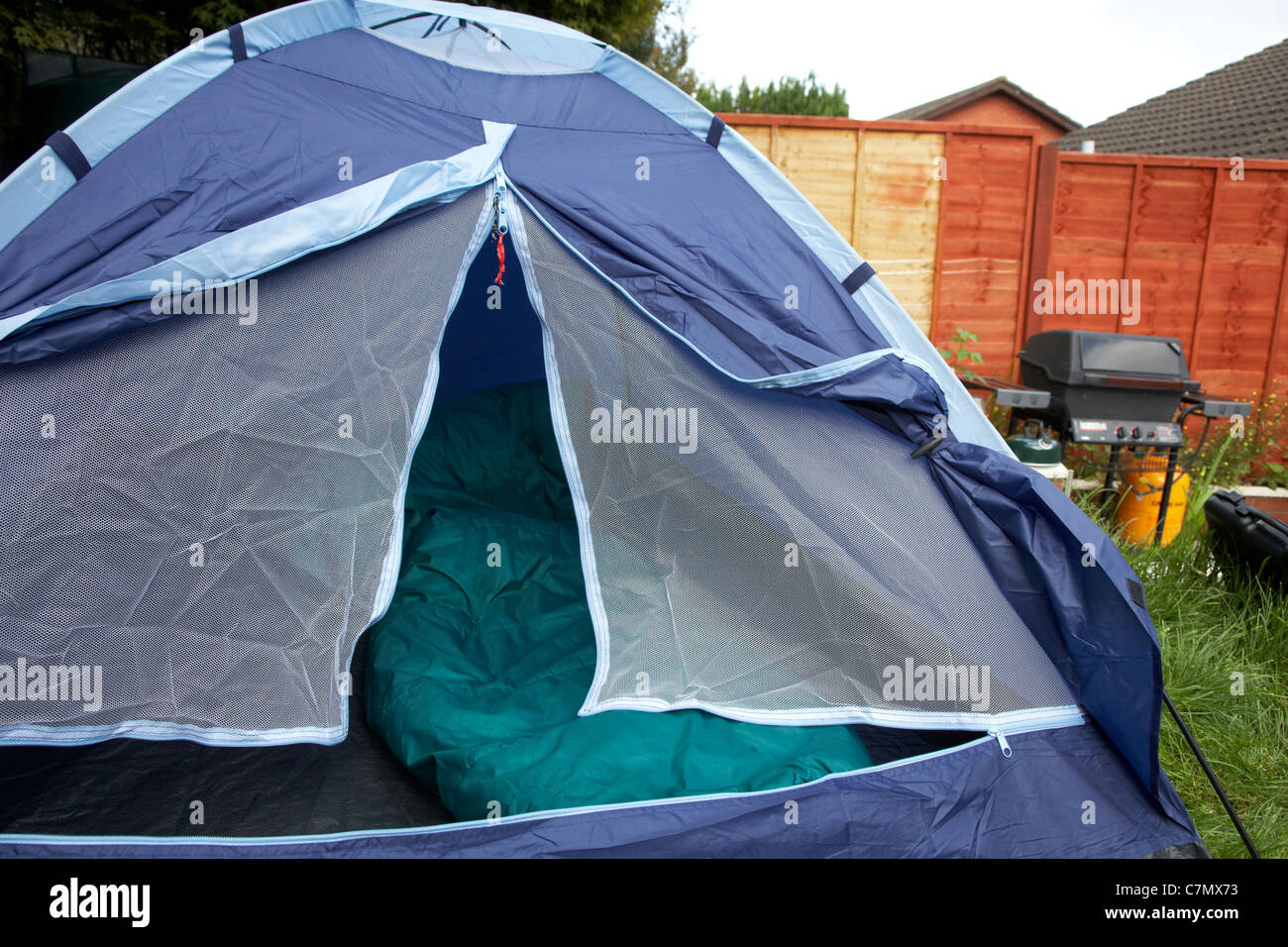 front door left open on a small dome tent pitched in the garden of the ...