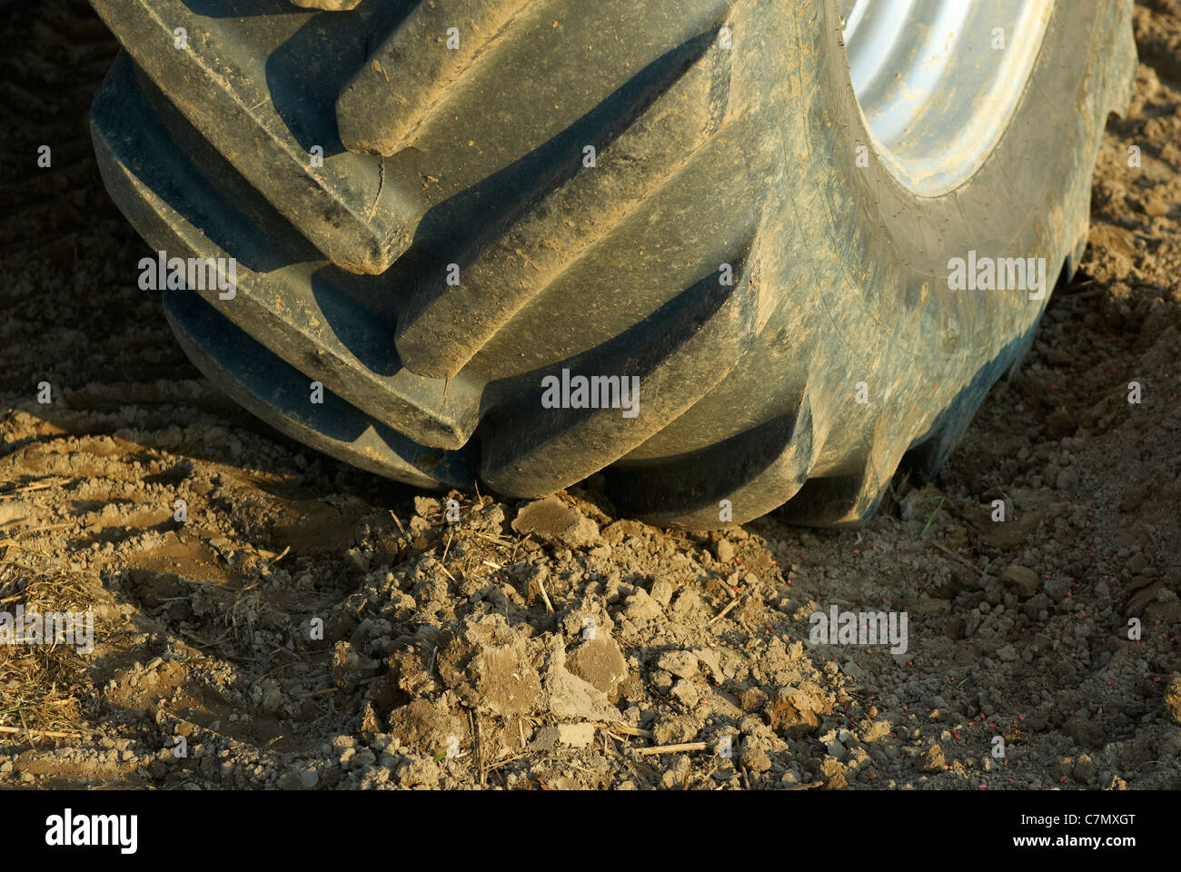 Track of tractor in soil autumn field Stock Photo - Alamy