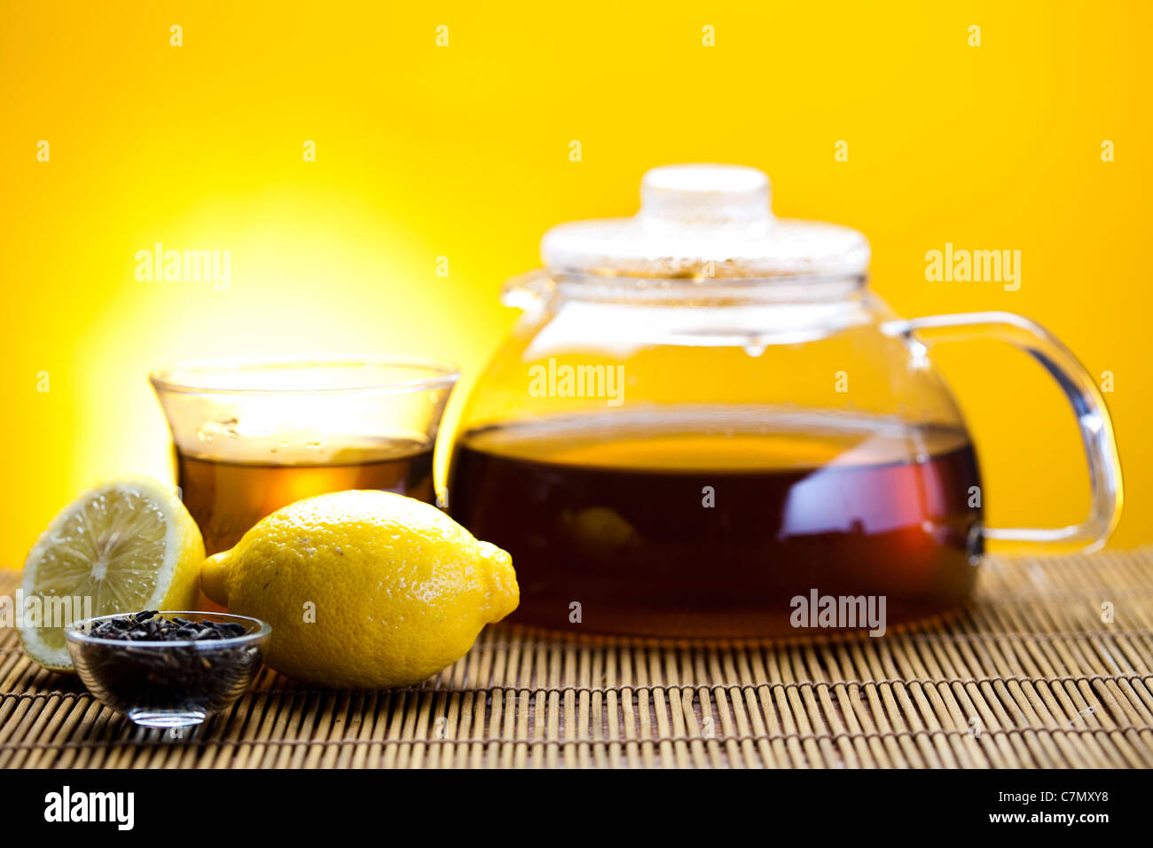 Glass teapot of tea with lemon Stock Photo - Alamy