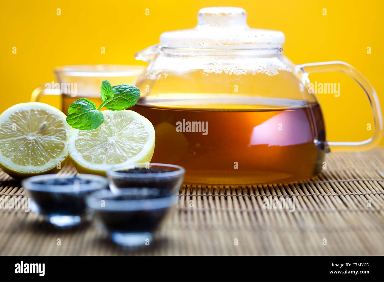 Glass teapot of tea with lemon Stock Photo - Alamy