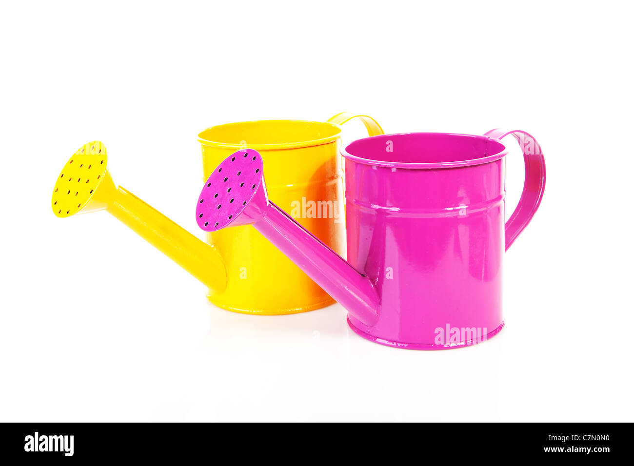 Two colorful watering cans over white background Stock Photo - Alamy