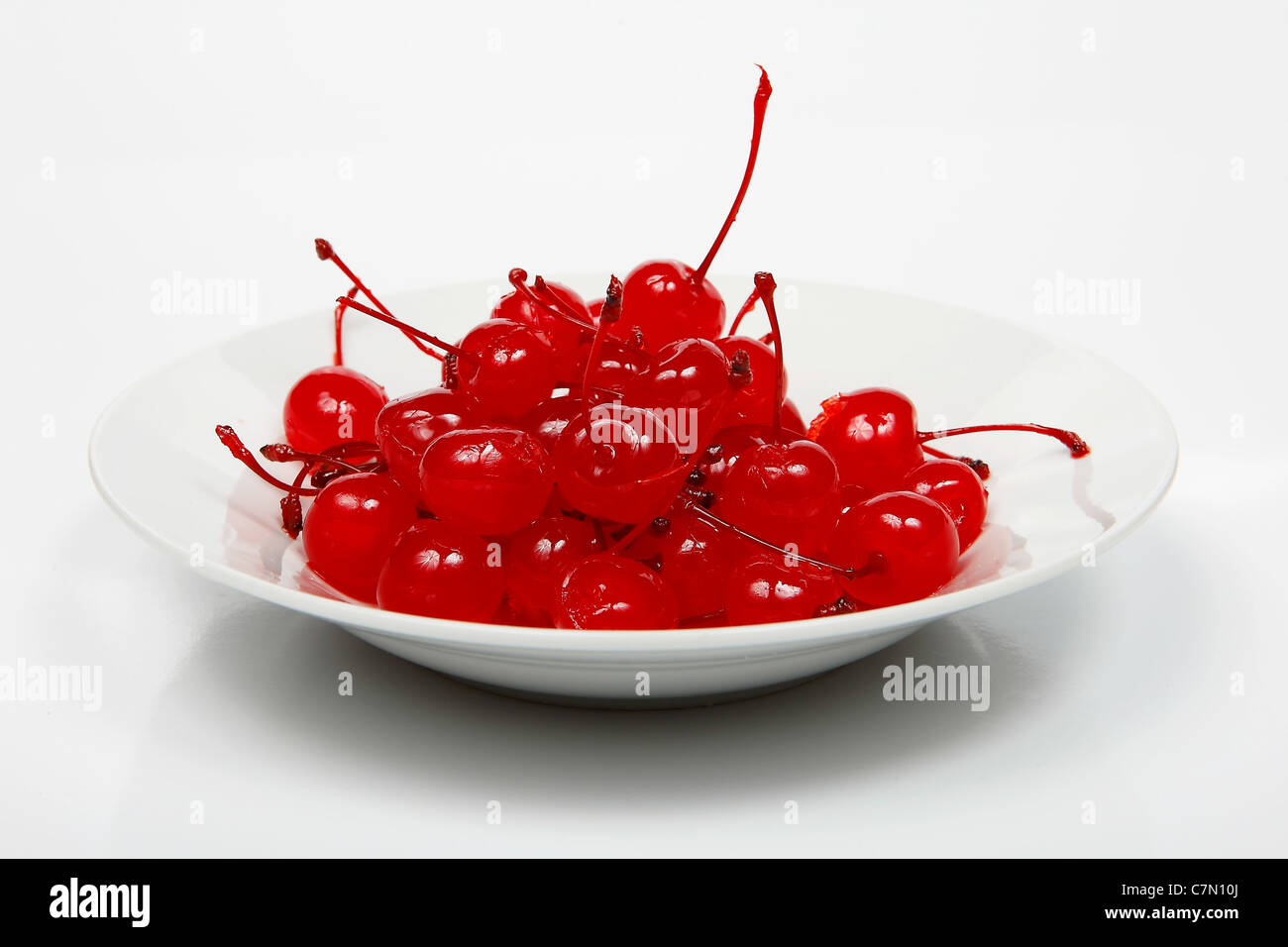 Bowl of cherries on white background Stock Photo - Alamy