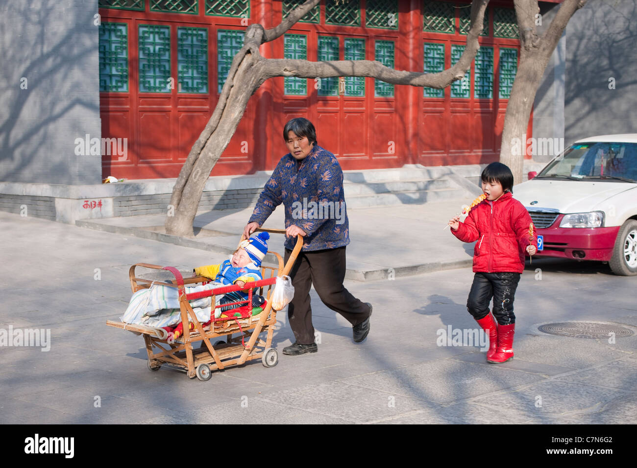 Older Chinese woman pushes rustic pram with baby Stock Photo - Alamy
