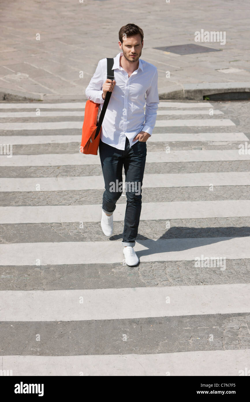 Man walking on crosswalk, Paris, Ile-de-France, France Stock Photo - Alamy