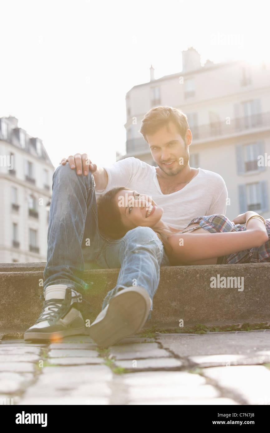 Woman lying on lap of a man at the ledge of a canal, Paris, Ile-de ...