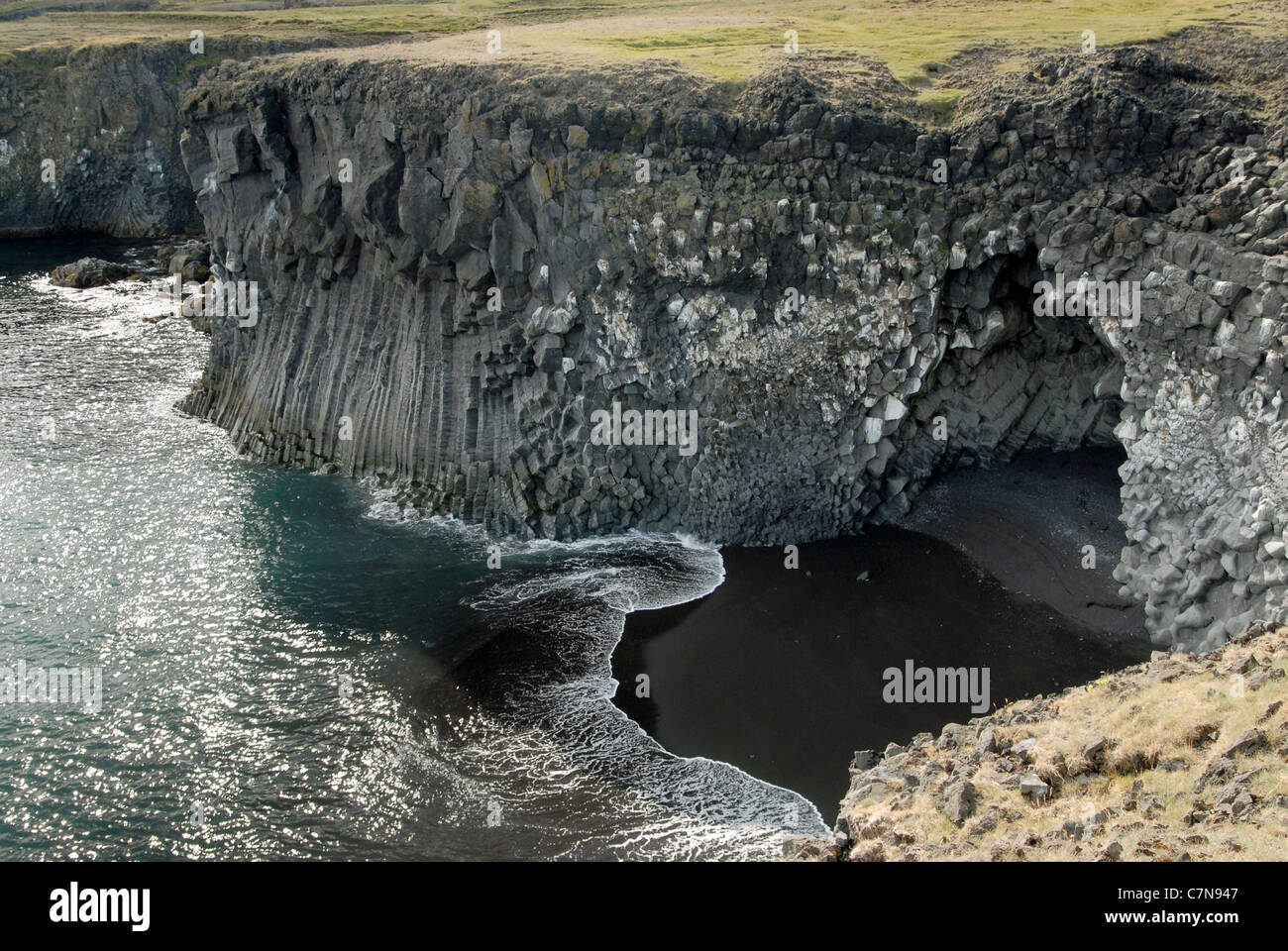 Valasnös basalt cliffs and sea cave Baðstofa at Hellnar on the ...