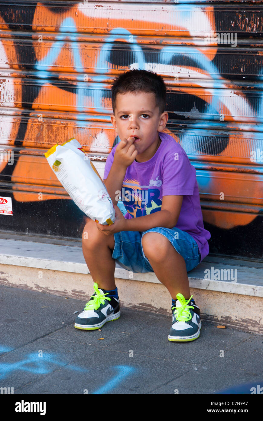 Boy eating snack Stock Photo - Alamy