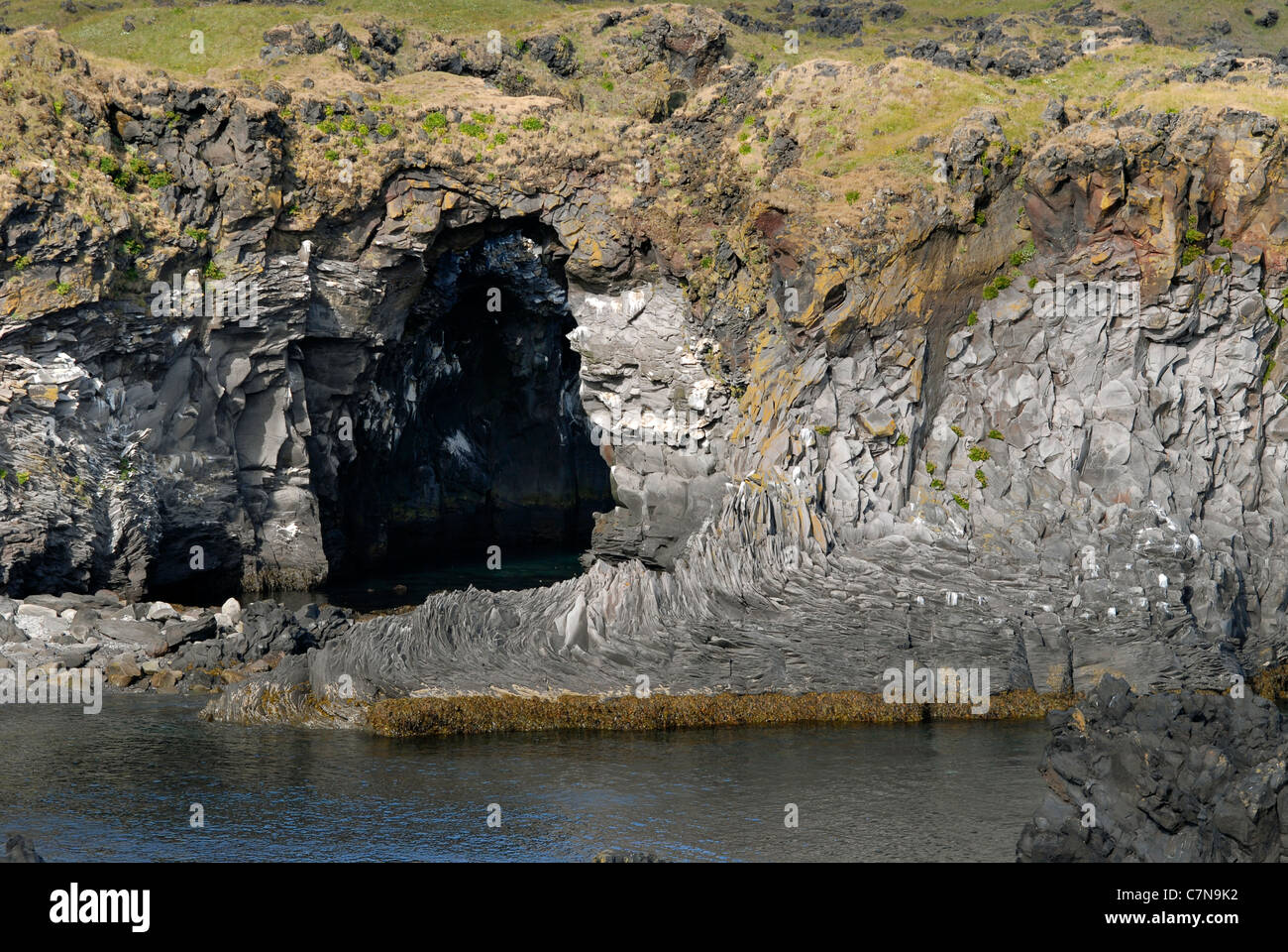 Valasnös basalt cliffs and sea cave Baðstofa at Hellnar on the ...