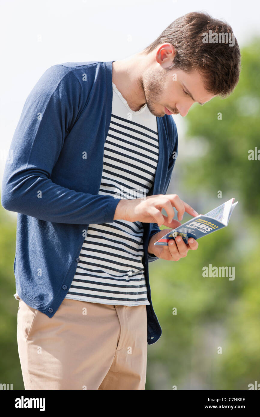 Man reading a travel guidebook, Paris, Ile-de-France, France Stock ...