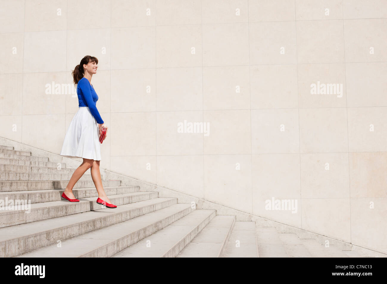 Woman moving down steps, Paris, Ile-de-France, France Stock Photo - Alamy