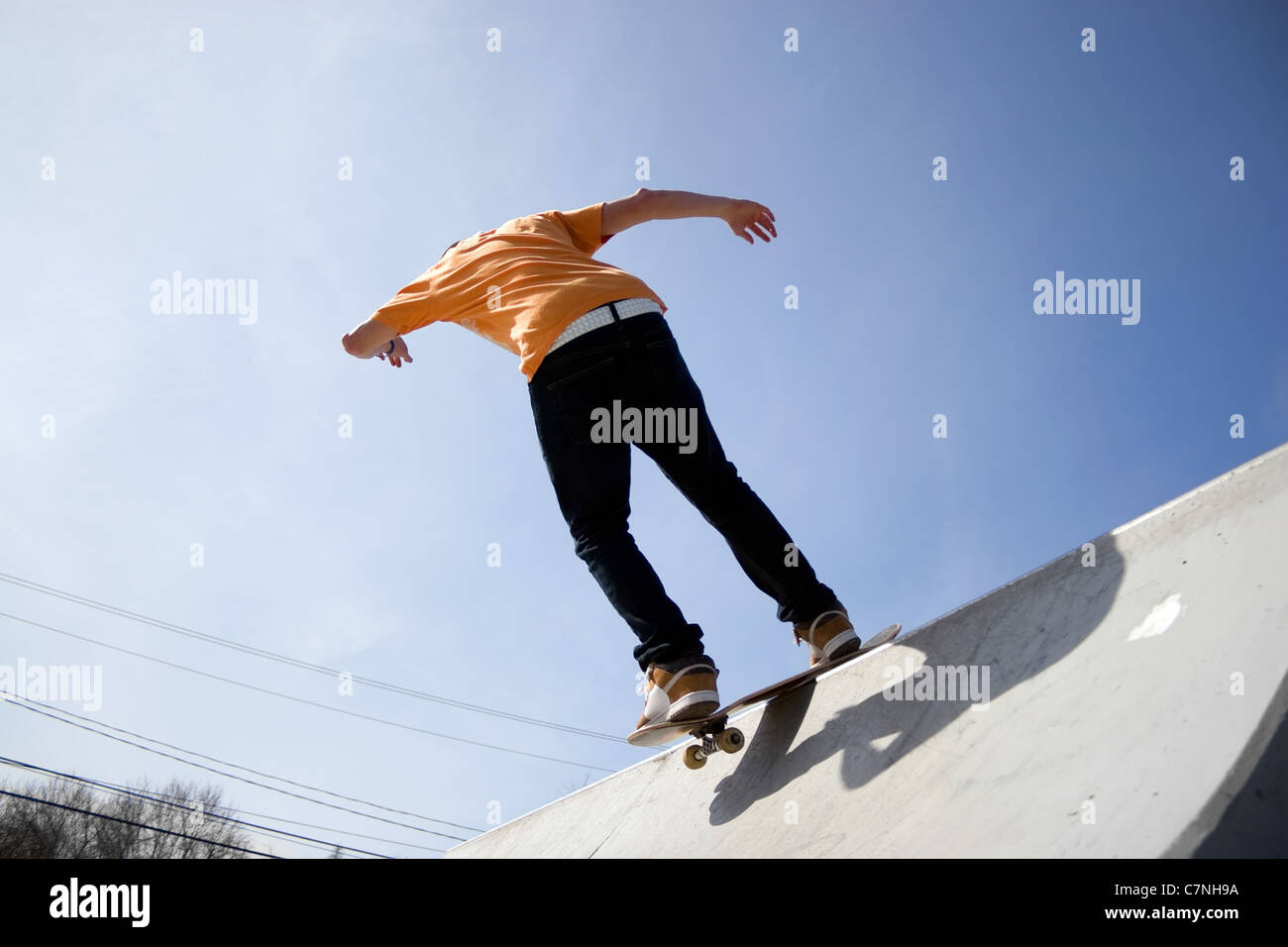 Action shot of a teenage skateboarder skating down a ramp at the skate ...