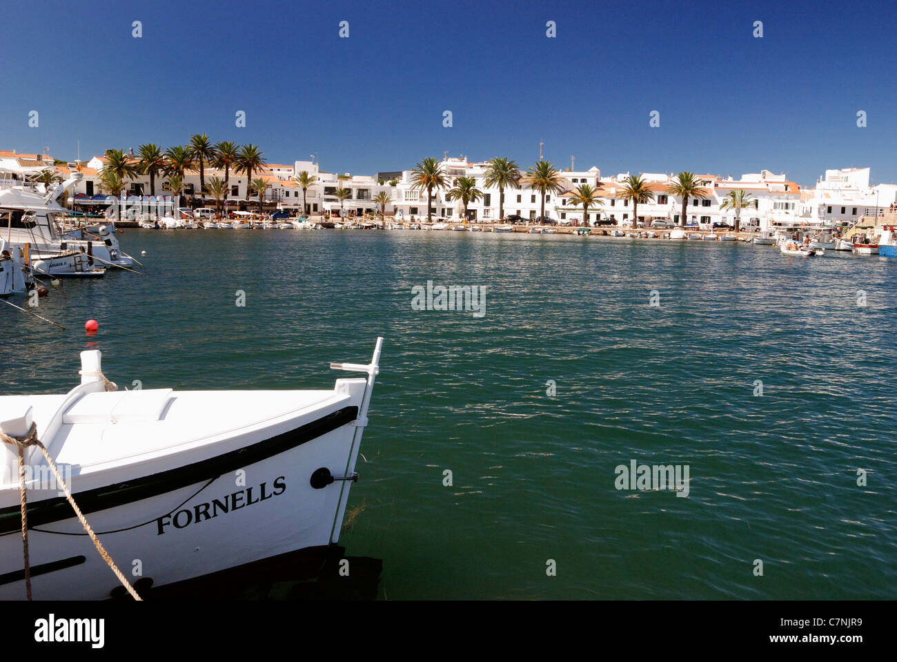 Fornells harbour with boat with Fornells name Stock Photo - Alamy
