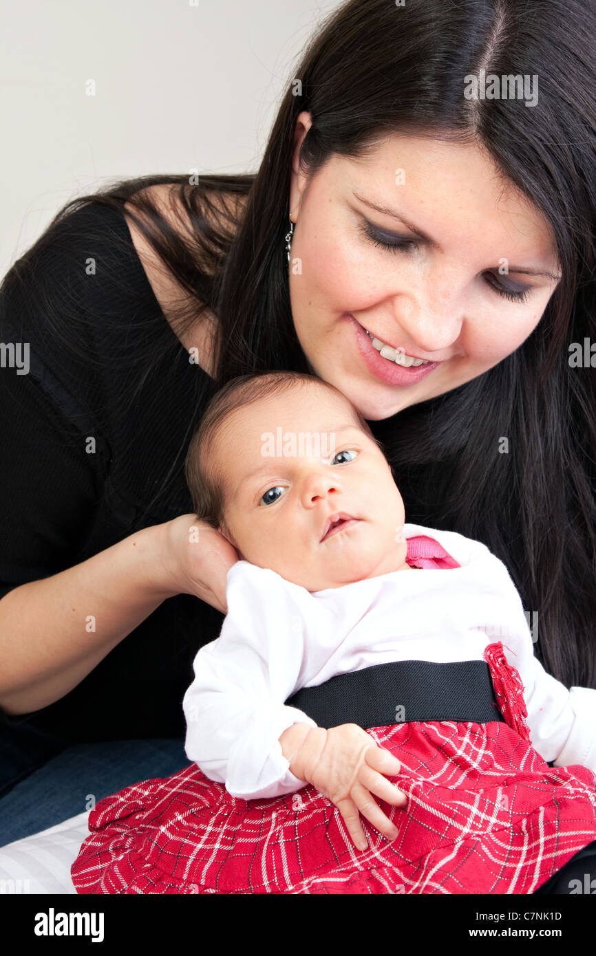 A newborn baby being held in the arms of her mother Stock Photo - Alamy