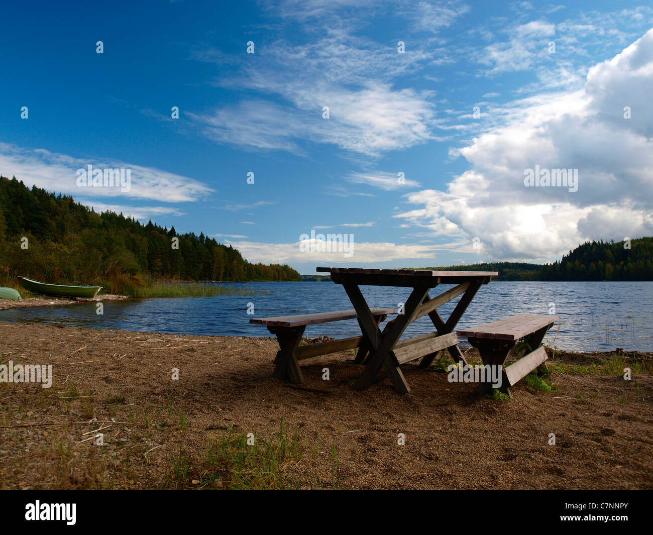 Wooden table with benches at lake coast Stock Photo - Alamy