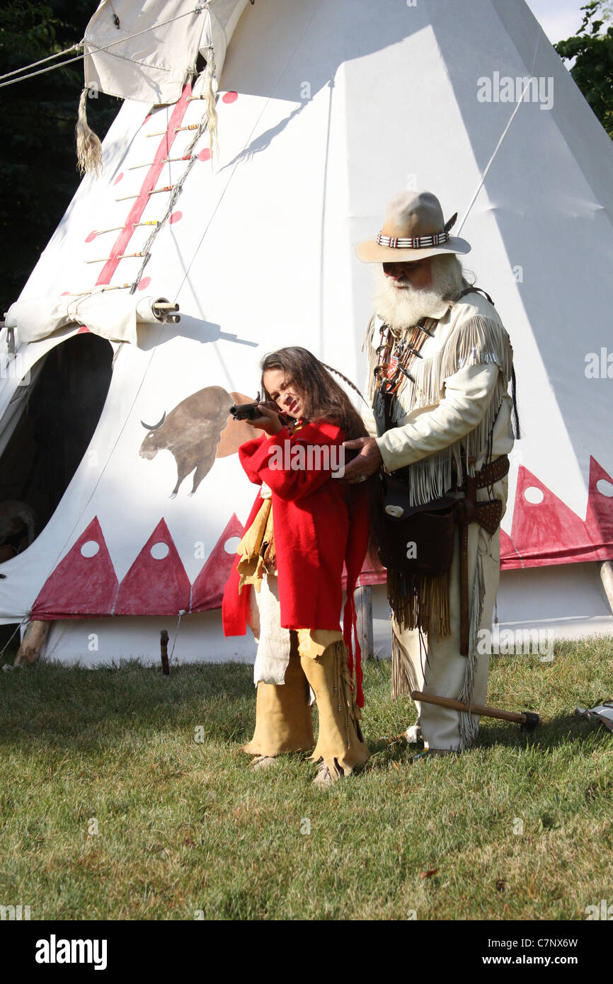 A Native American Indian boy learning how to shoot a gun Stock Photo ...