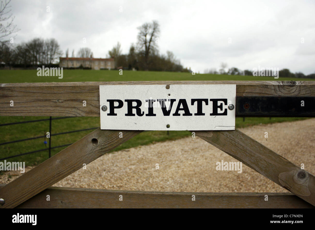 A private sign on a gate, with a big house in the background in ...
