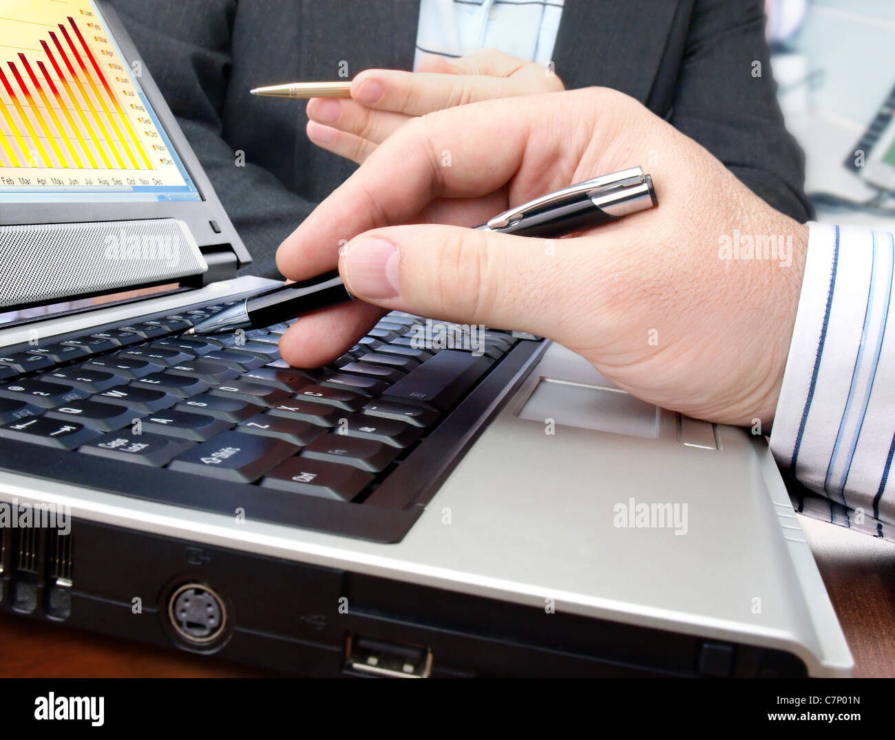Analyzing data and charts on computer screen Stock Photo - Alamy