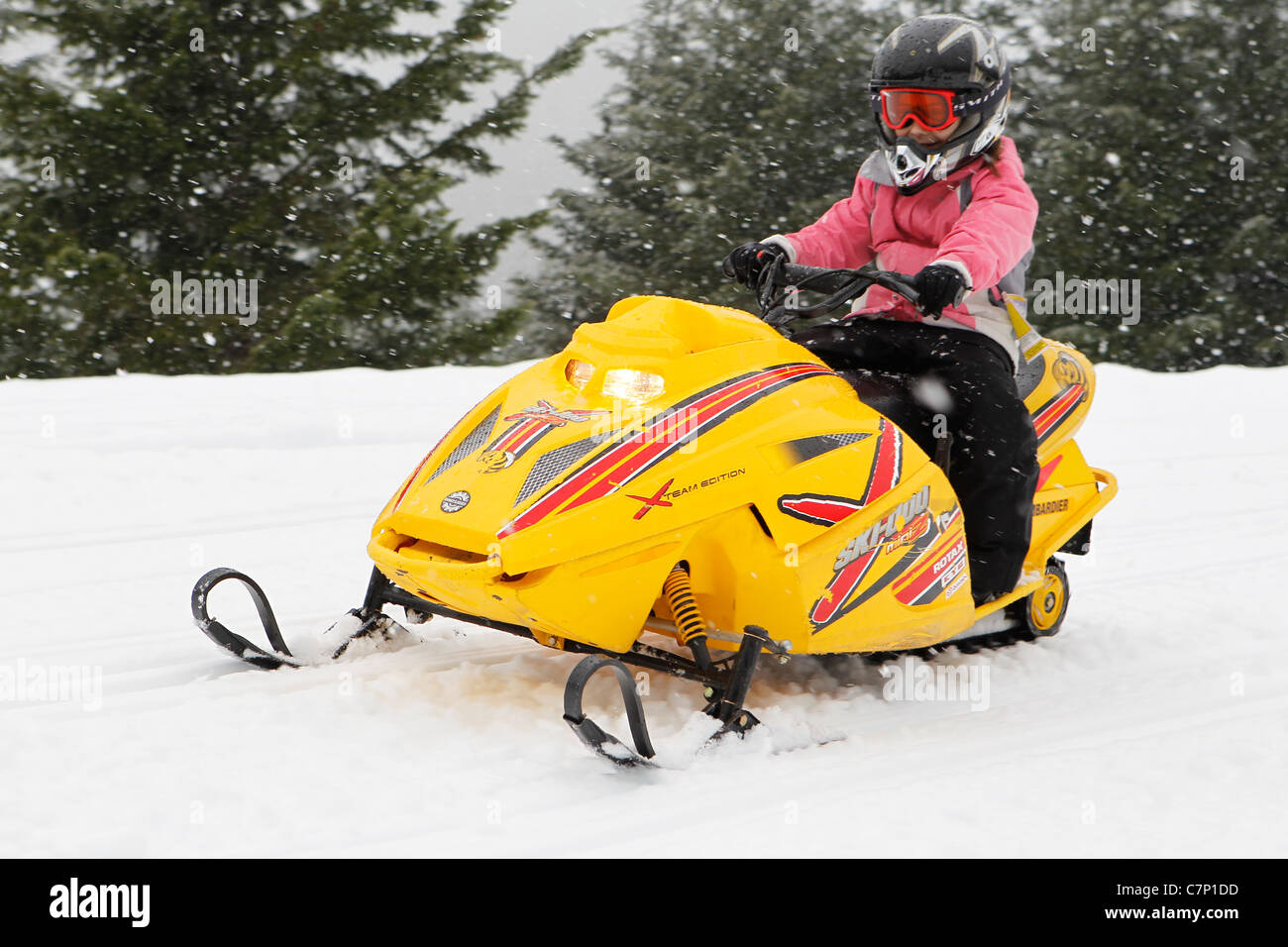 child riding a mini Snowmobile Stock Photo - Alamy