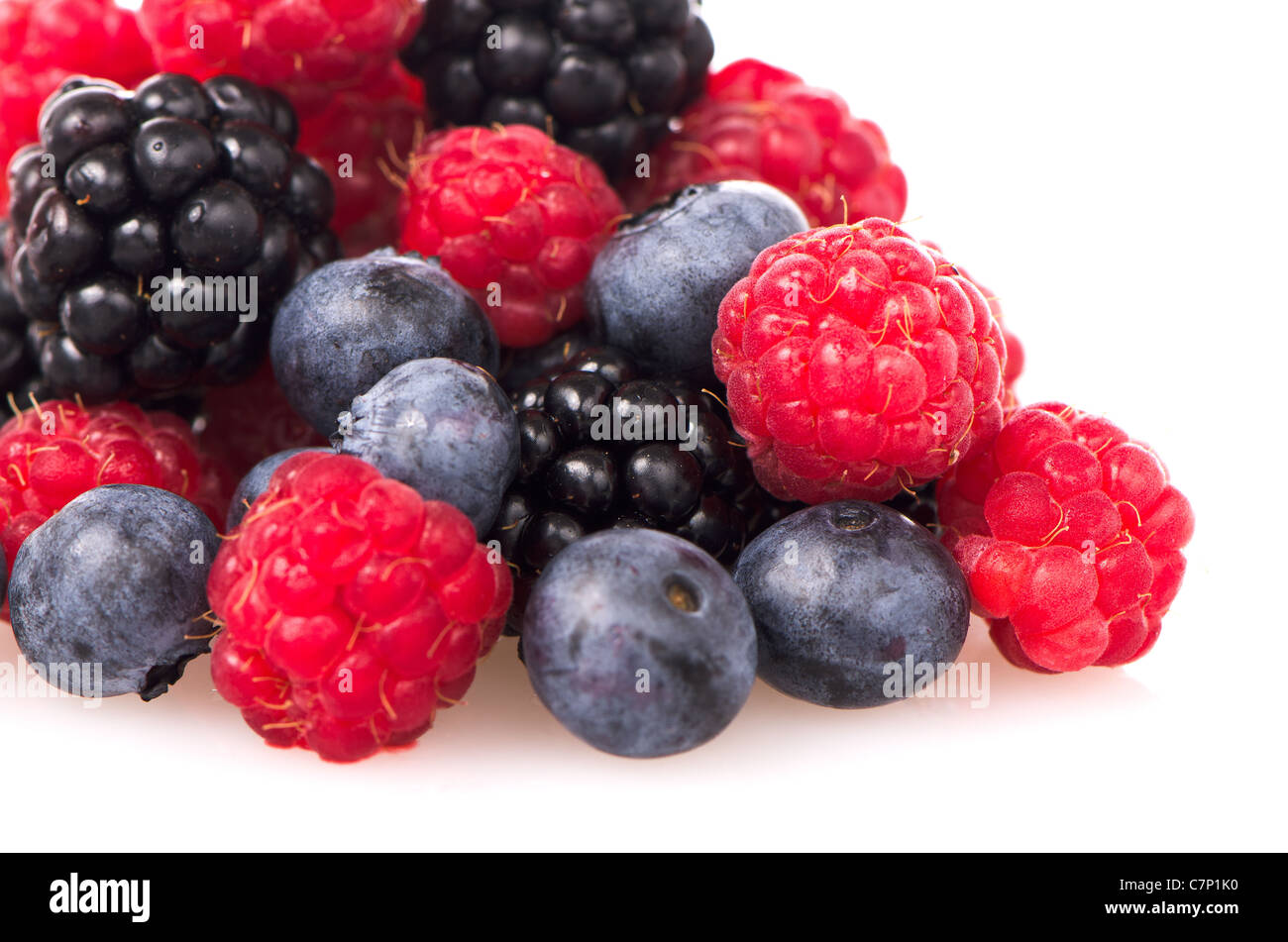 Red fruits soft focus on white reflective background Stock Photo - Alamy